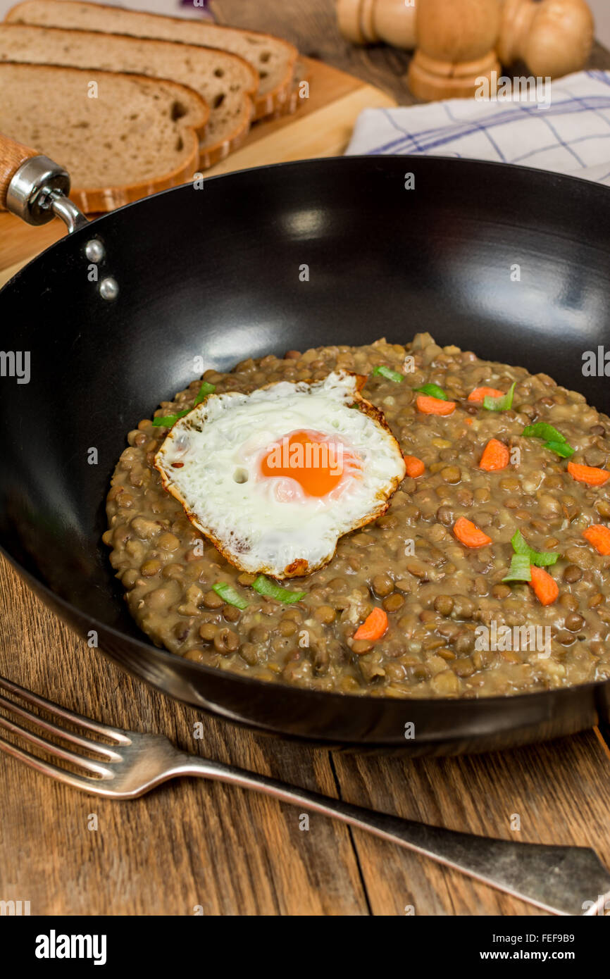 Traditional lentils or lens with egg and bread Stock Photo - Alamy