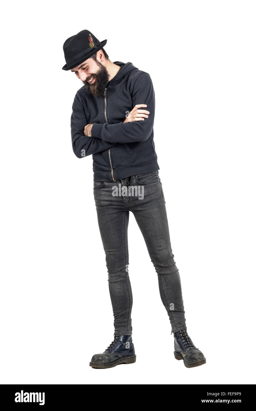 Happy spontaneous laughing hipster with fedora hat looking down. Full ...