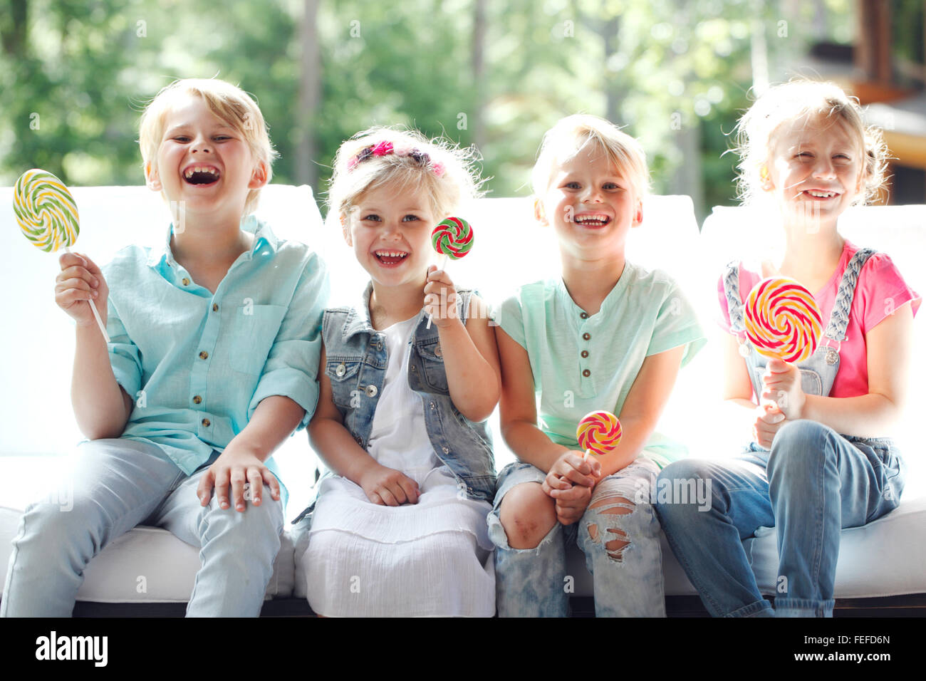 Group of happy smiling children with lollipops outdoors Stock Photo - Alamy