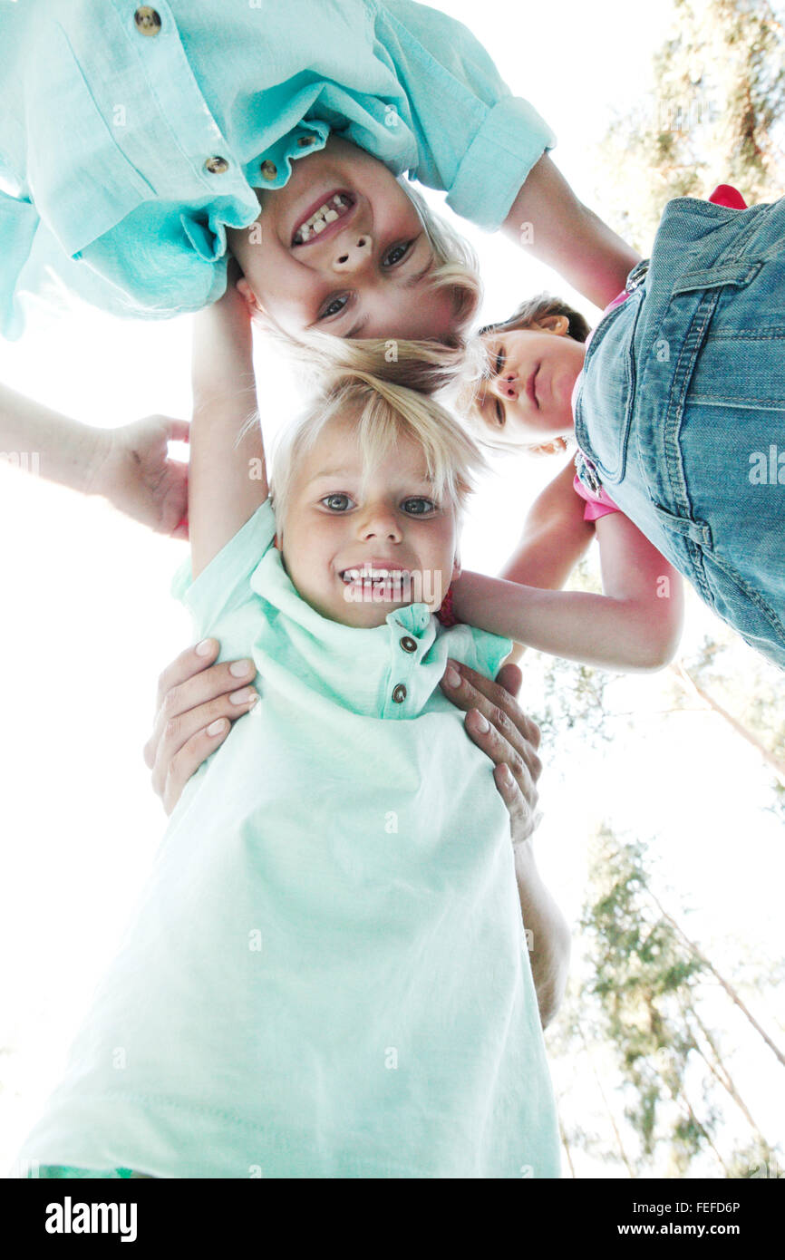 Group of smiling children looking down into camera Stock Photo - Alamy