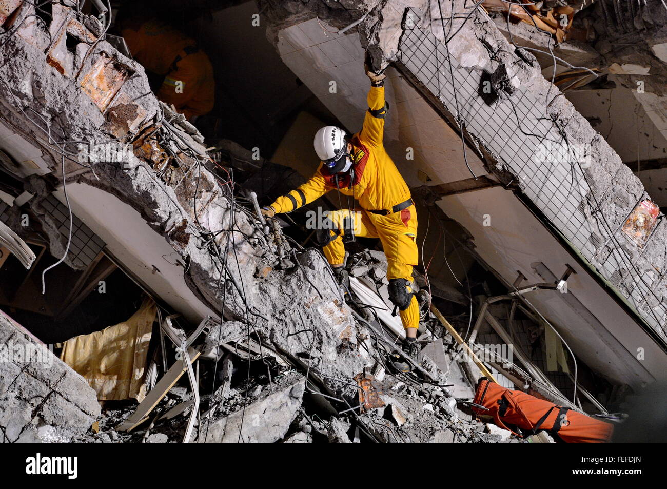 Tainan, China's Taiwan. 6th Feb, 2016. A rescuer tries to look for ...