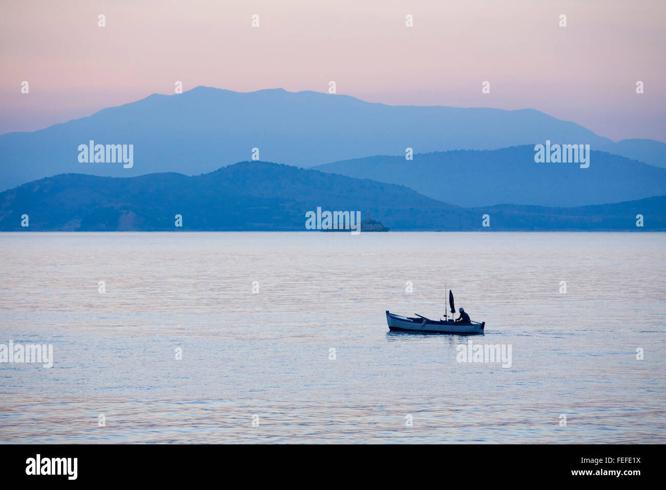 Kassiopi, Corfu, Ionian Islands, Greece. Small boat crossing the Strait ...