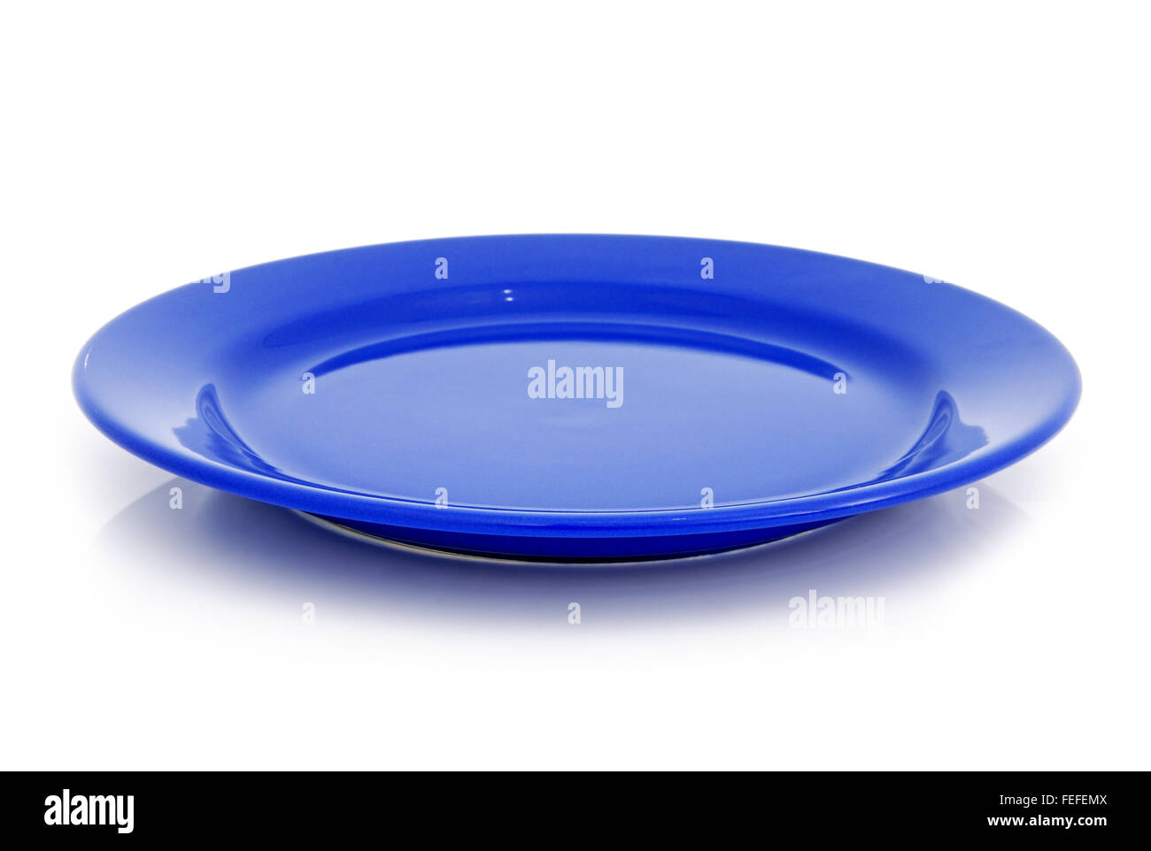 Empty blue plate white background Cut Out Stock Images & Pictures - Alamy