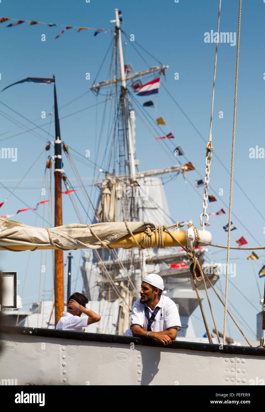 Sailor looking away on a boat with masts and rigging behind Stock Photo ...