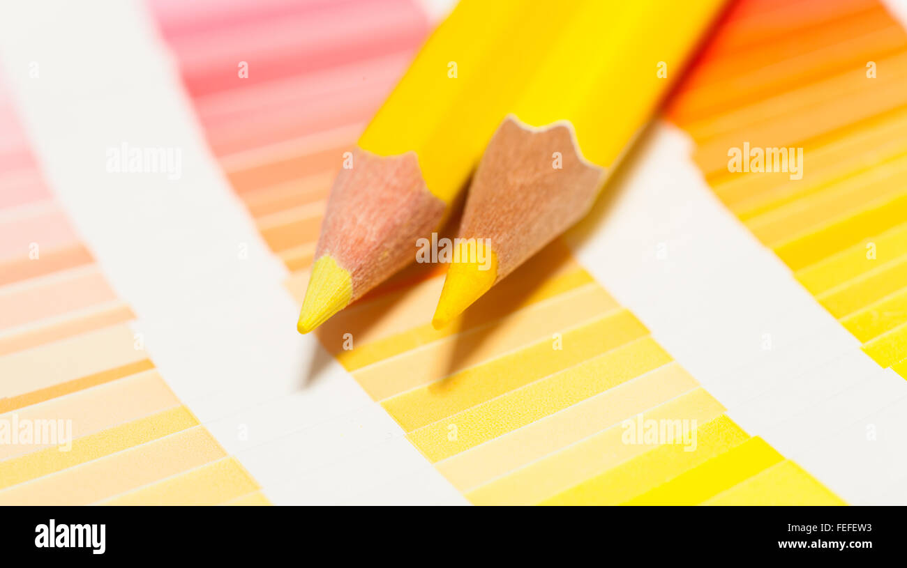 yellow colored pencils and color chart of all colors Stock Photo - Alamy