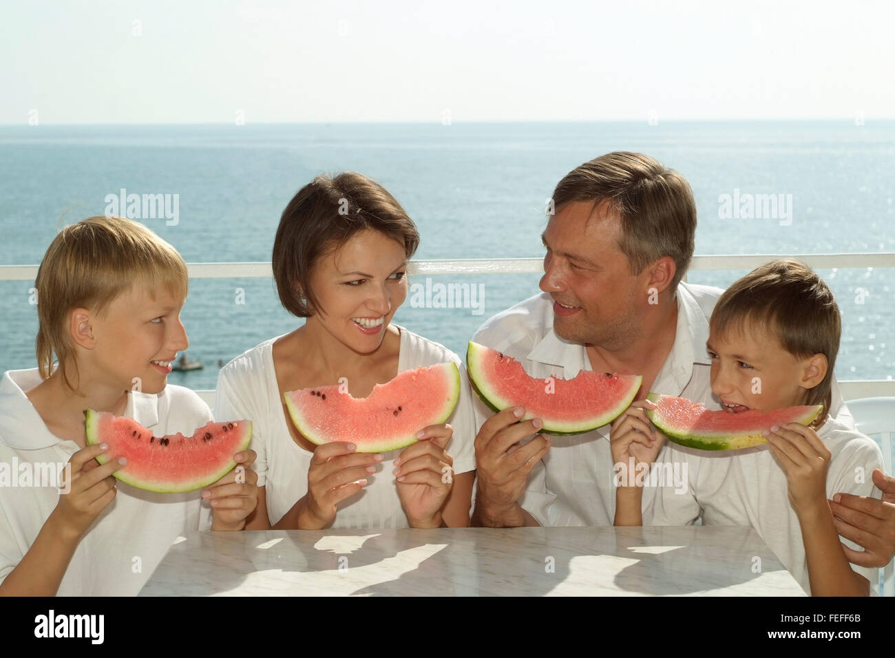 Family eating watermelon Stock Photo - Alamy