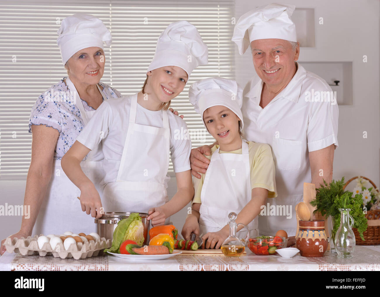 Happy family cooking together Stock Photo - Alamy