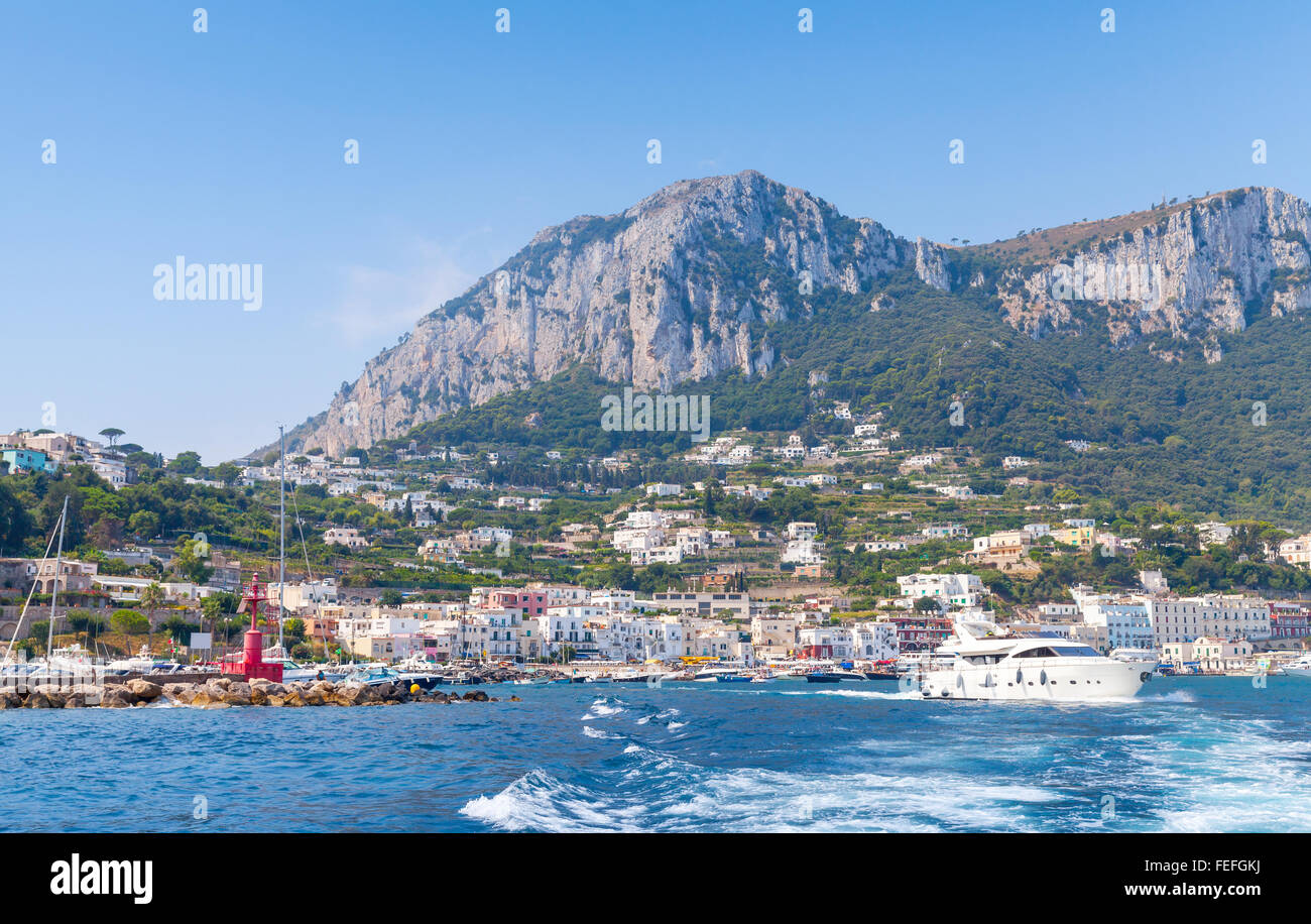 Port of Capri, Italy. Pleasure boats go near breakwater with red ...