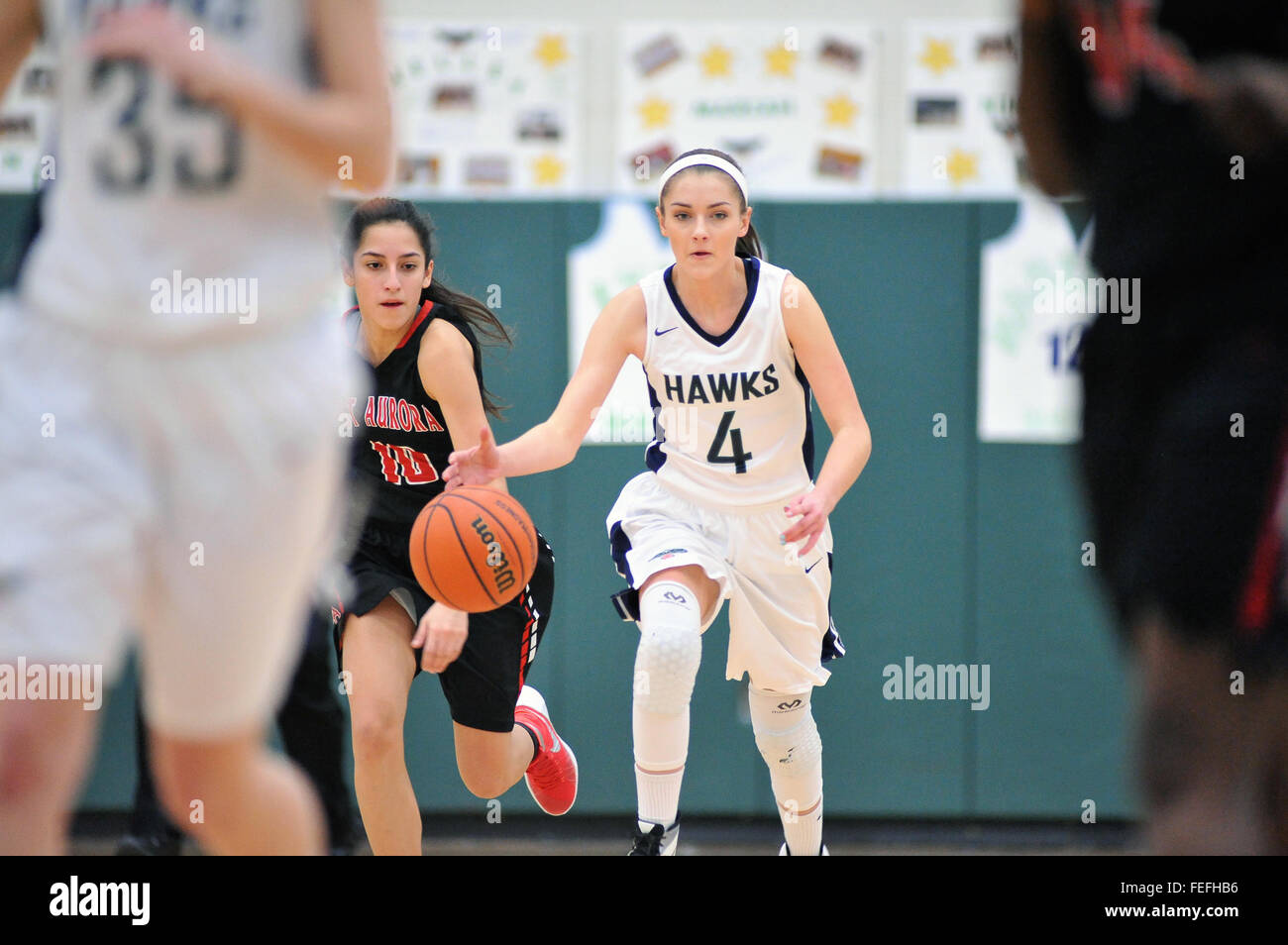Player dribbling across center court leading an offensive surge during ...