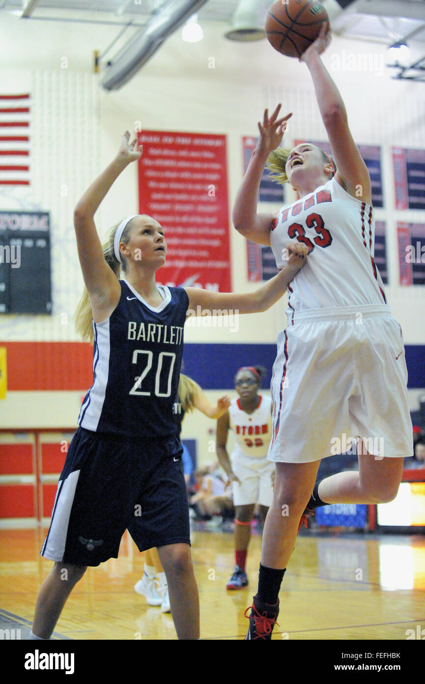 Player releasing a short shot over a defender during a high school ...
