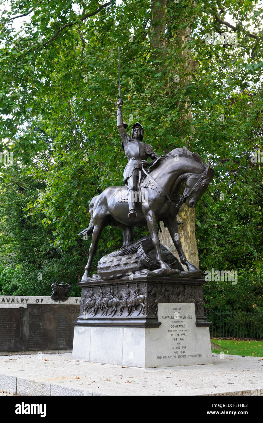 A memorial monument of a knight on horseback holding a sword high in ...