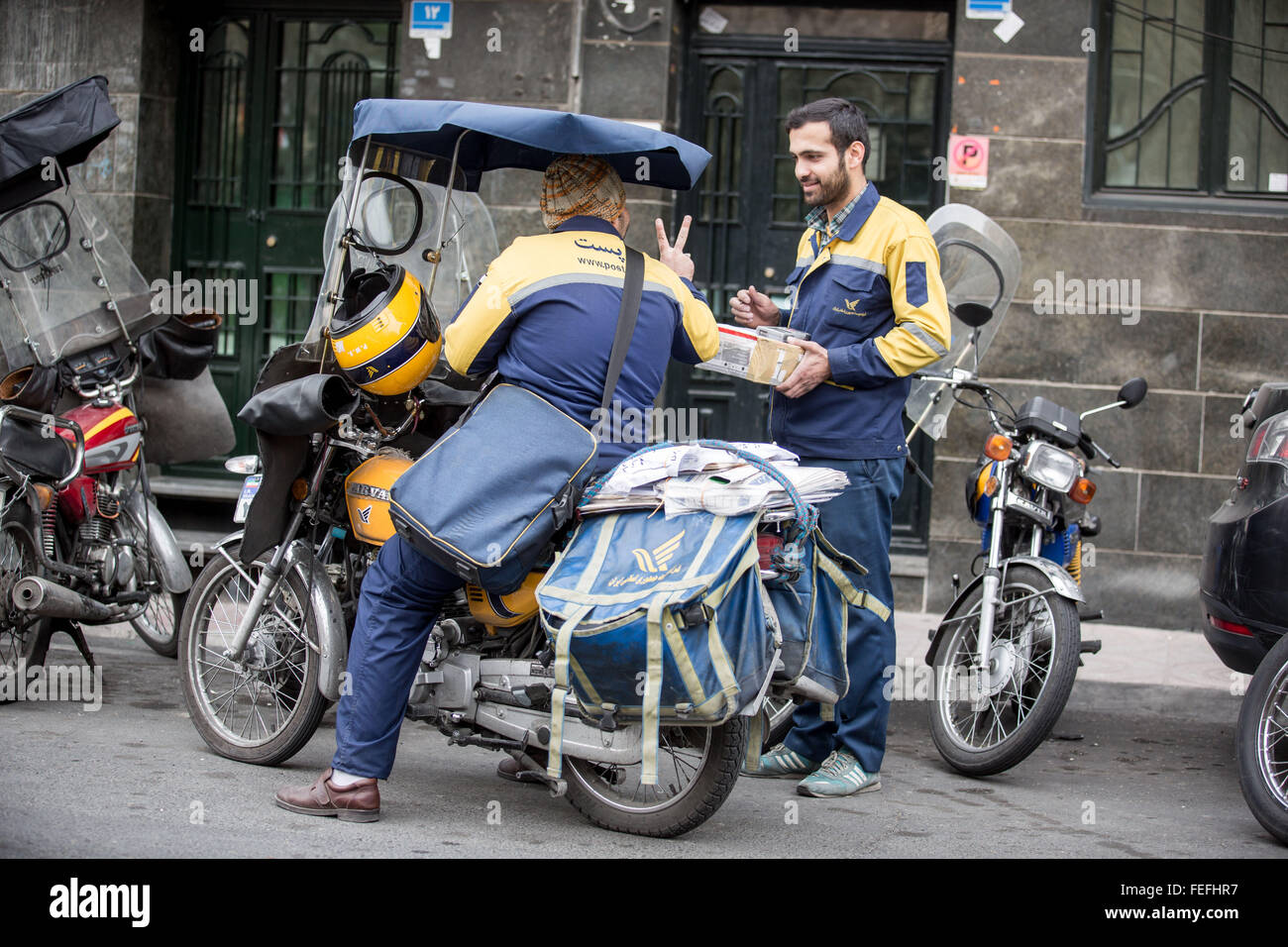 Two postmen on bikes hi-res stock photography and images - Alamy