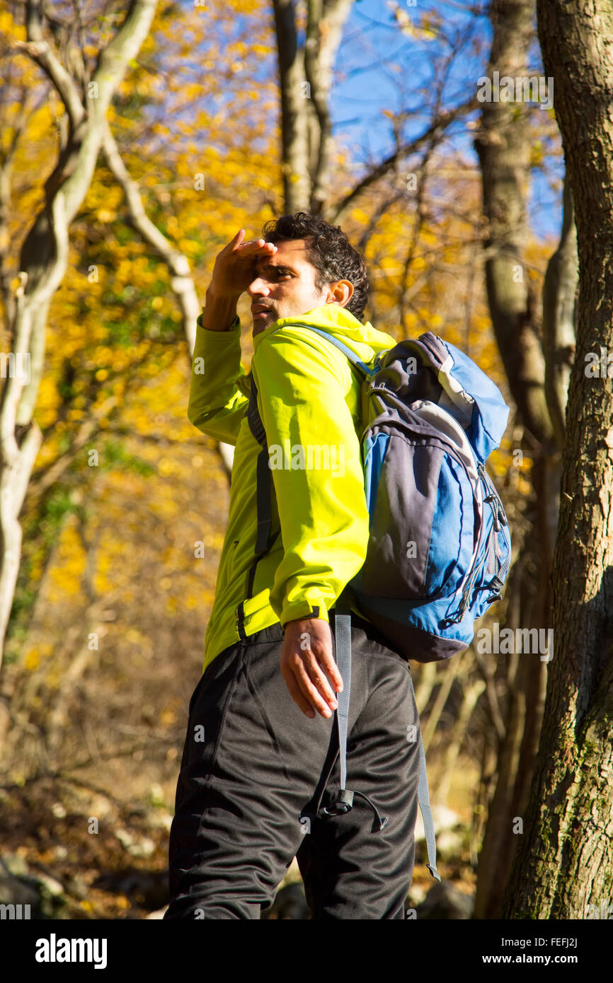 Young man hiking in the forest Stock Photo - Alamy