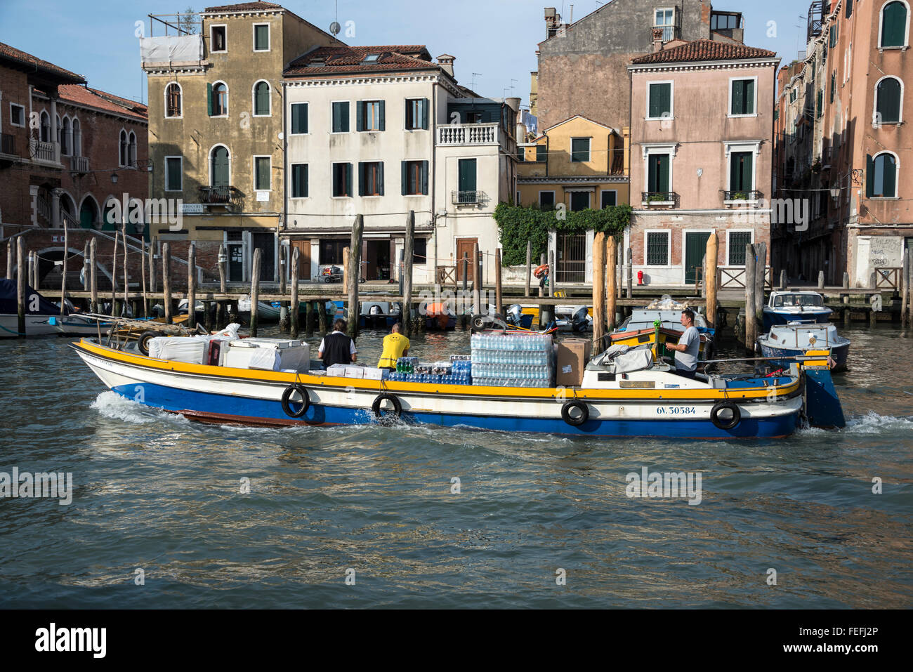 A stack of drinking water bottles being transported by barge for ...