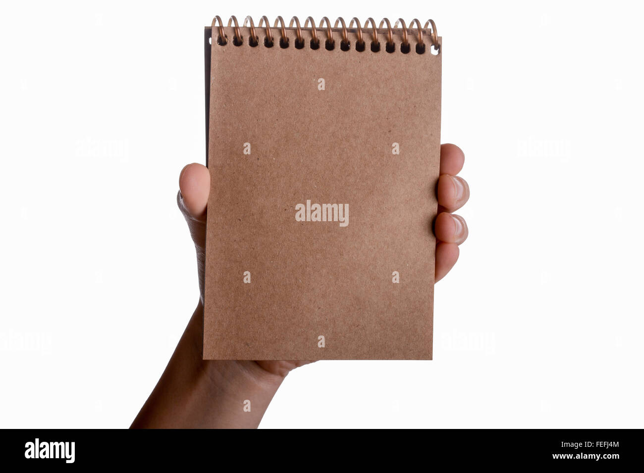 Hand holding a spiral notebook Stock Photo - Alamy