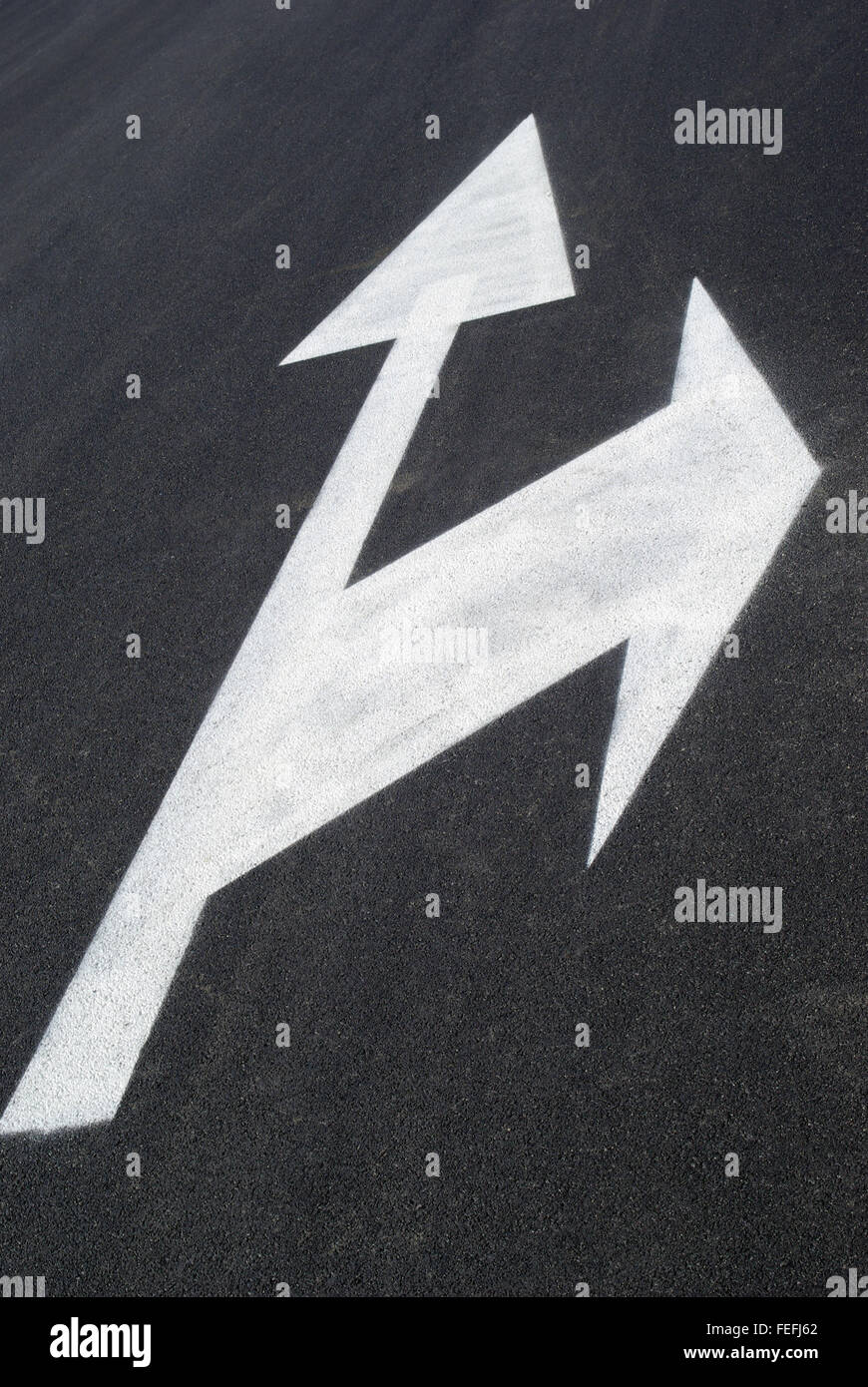 Direction arrow on the road Stock Photo - Alamy