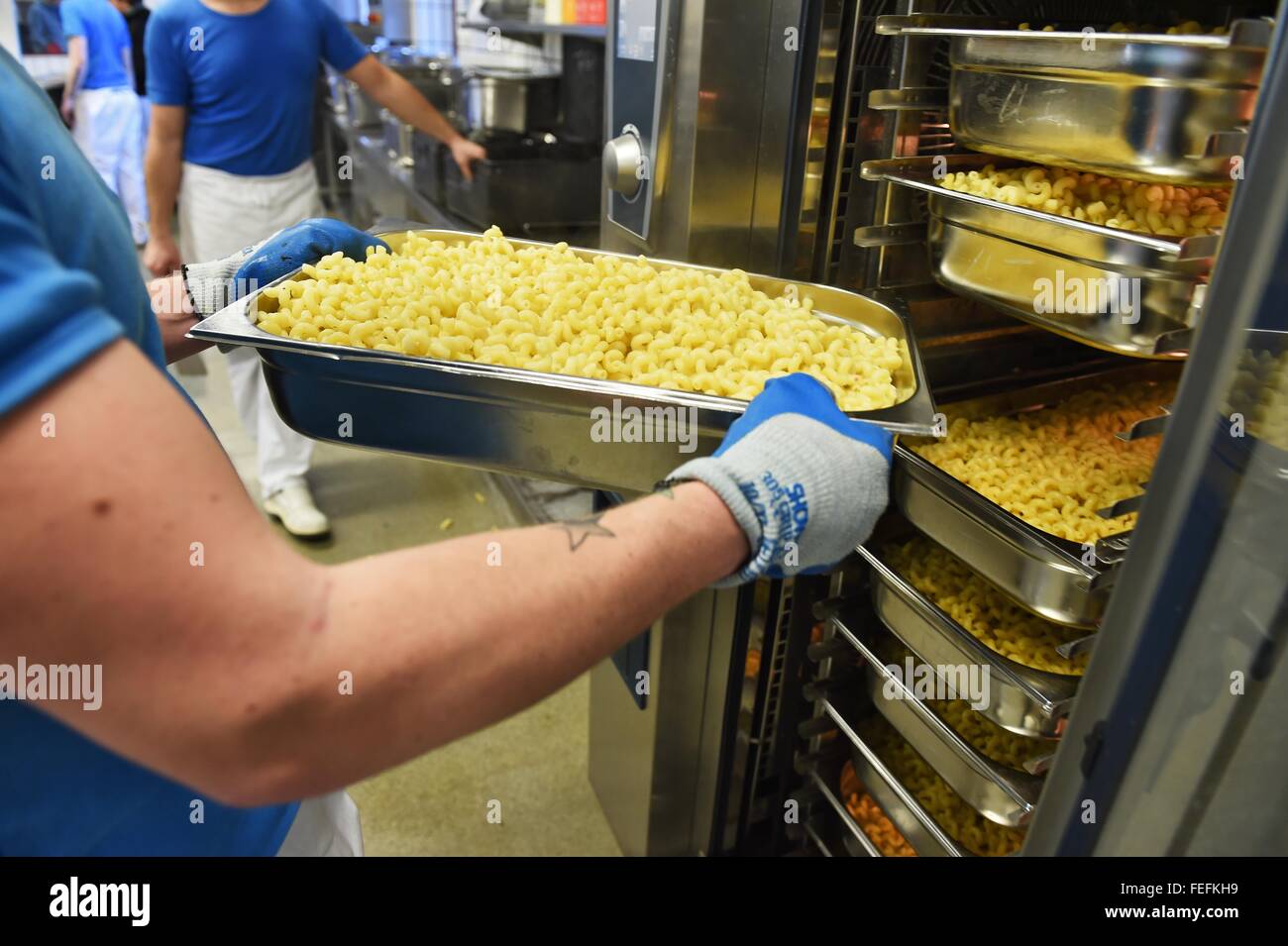 Ulm, Germany. 20th Jan, 2016. An inmate places a tray of noodles in the ...