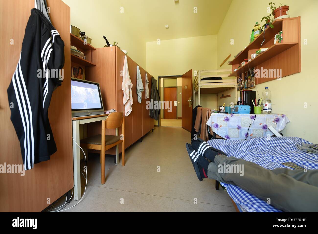 Ulm, Germany. 20th Jan, 2016. An inmate lies in his cell, which he ...
