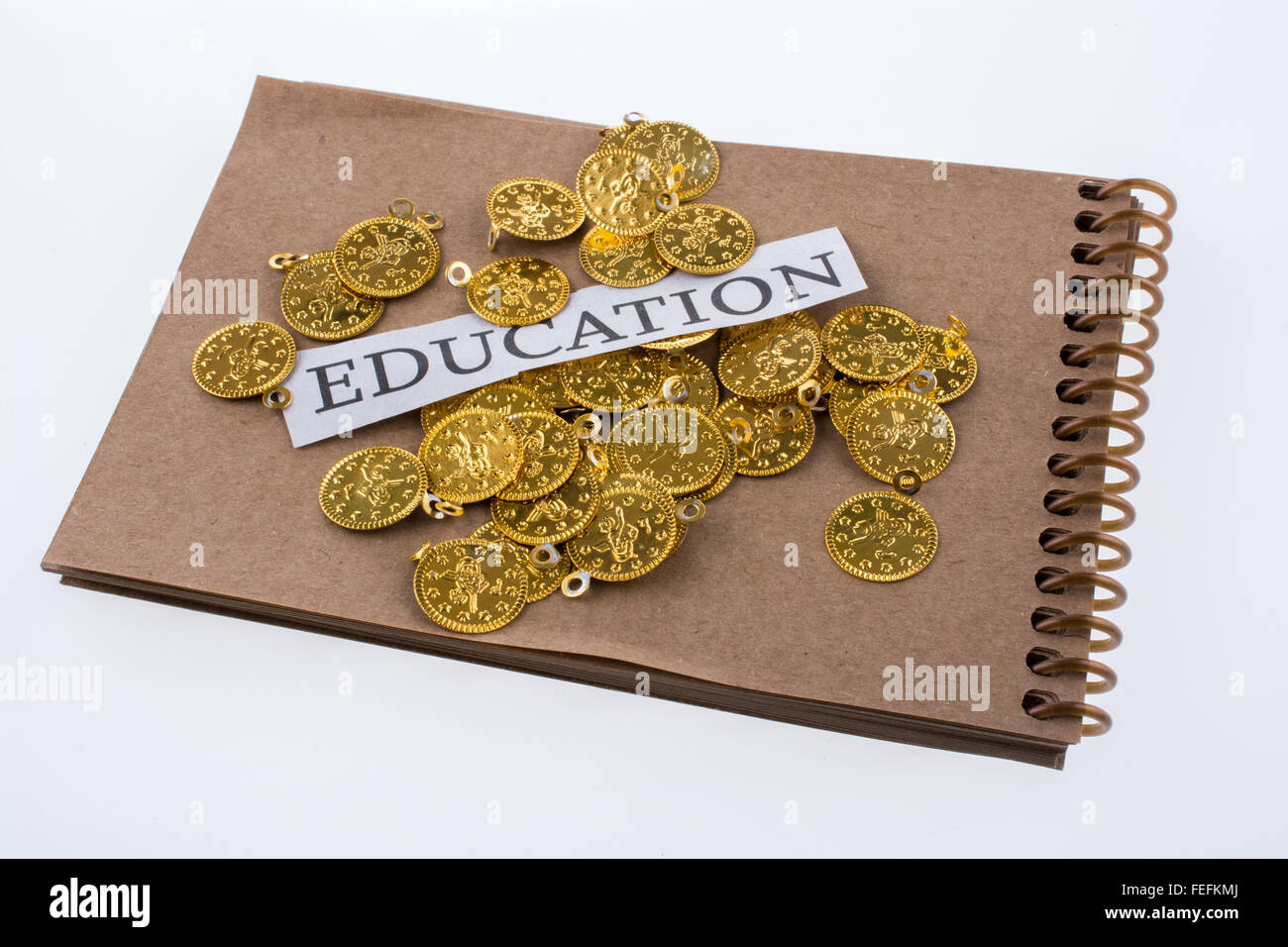 Education written paper among the gold coins Stock Photo - Alamy