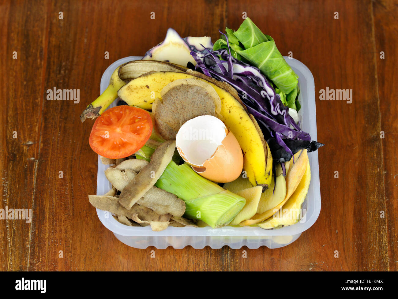 Kitchen vegetable and fruit food waste, collected in re-used packaging ...