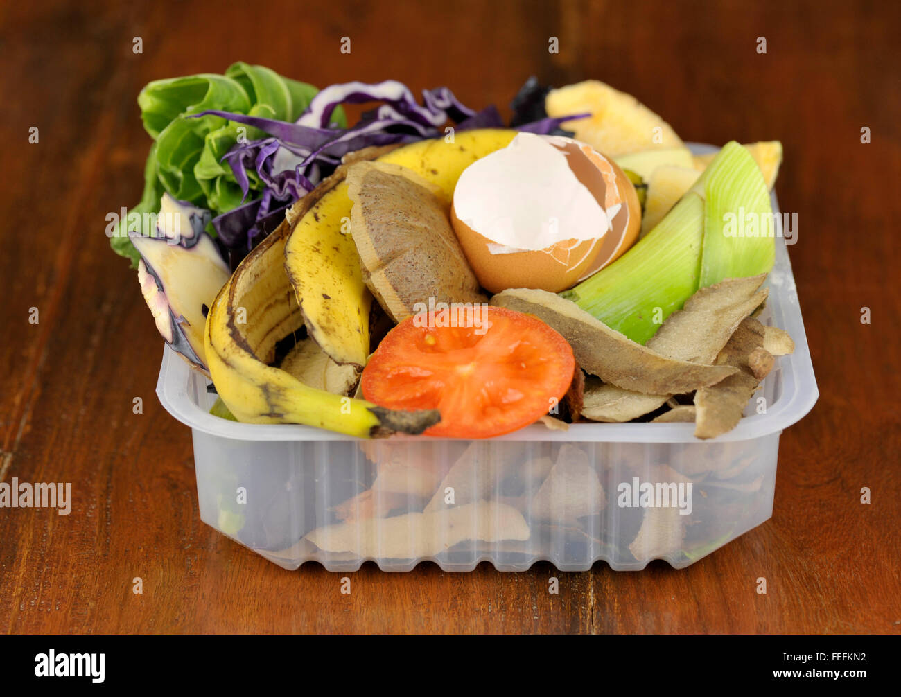 Kitchen vegetable and fruit food waste, collected in re-used packaging ...