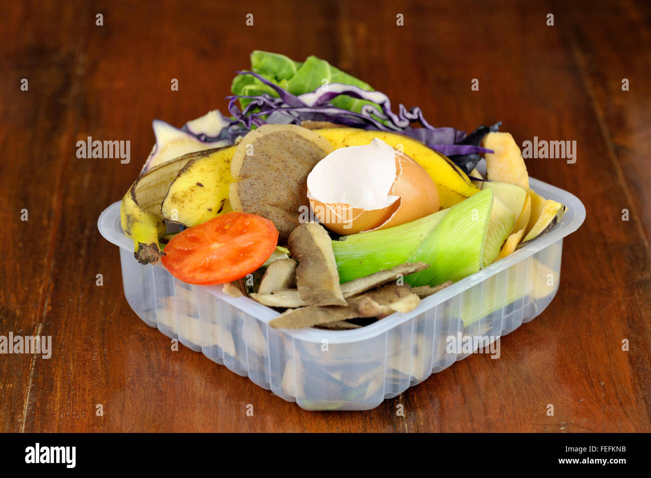 Kitchen vegetable and fruit food waste, collected in re-used packaging ...