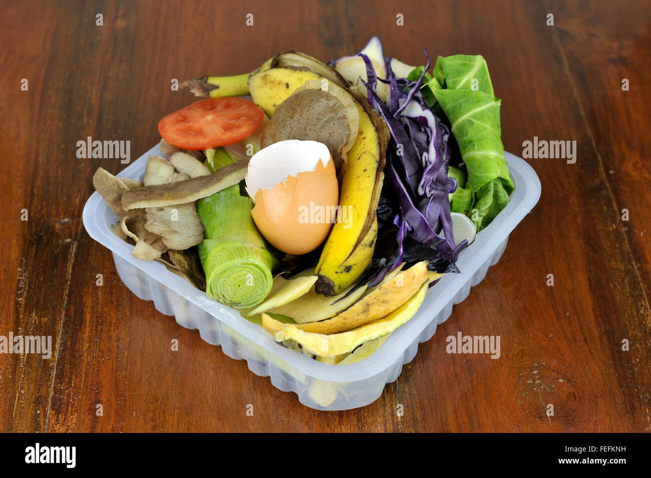 Kitchen vegetable and fruit food waste, collected in re-used packaging ...