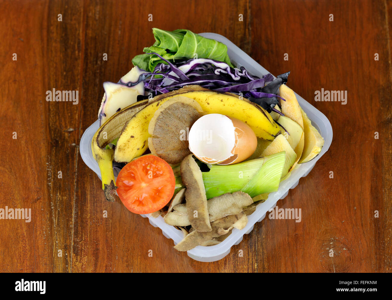 Kitchen vegetable and fruit food waste, collected in re-used packaging ...