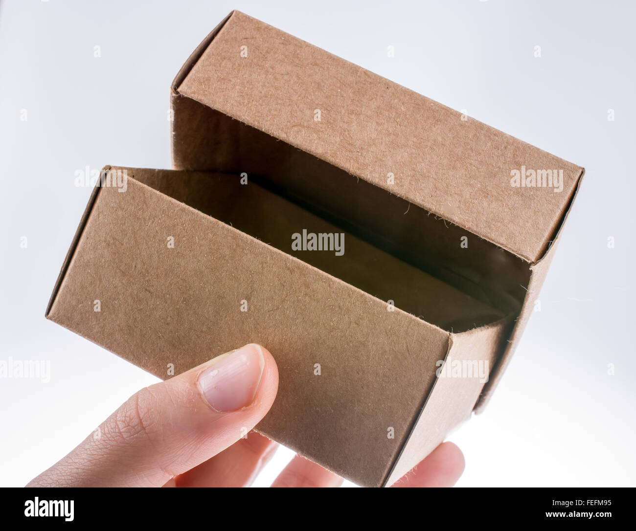 Hand holding cardboard Box on a white background Stock Photo - Alamy