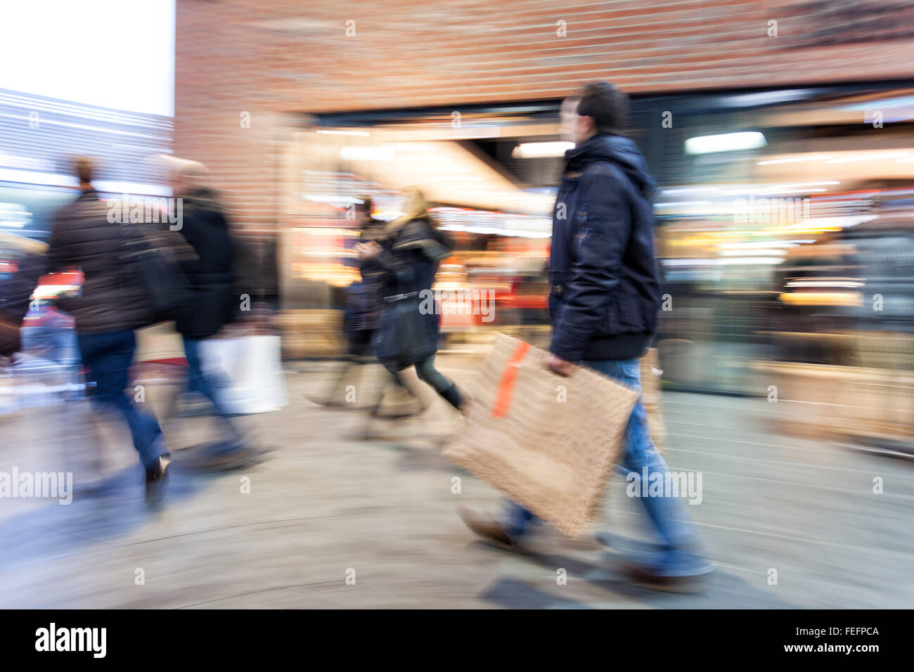 A shopper walking past a store window Stock Photo - Alamy