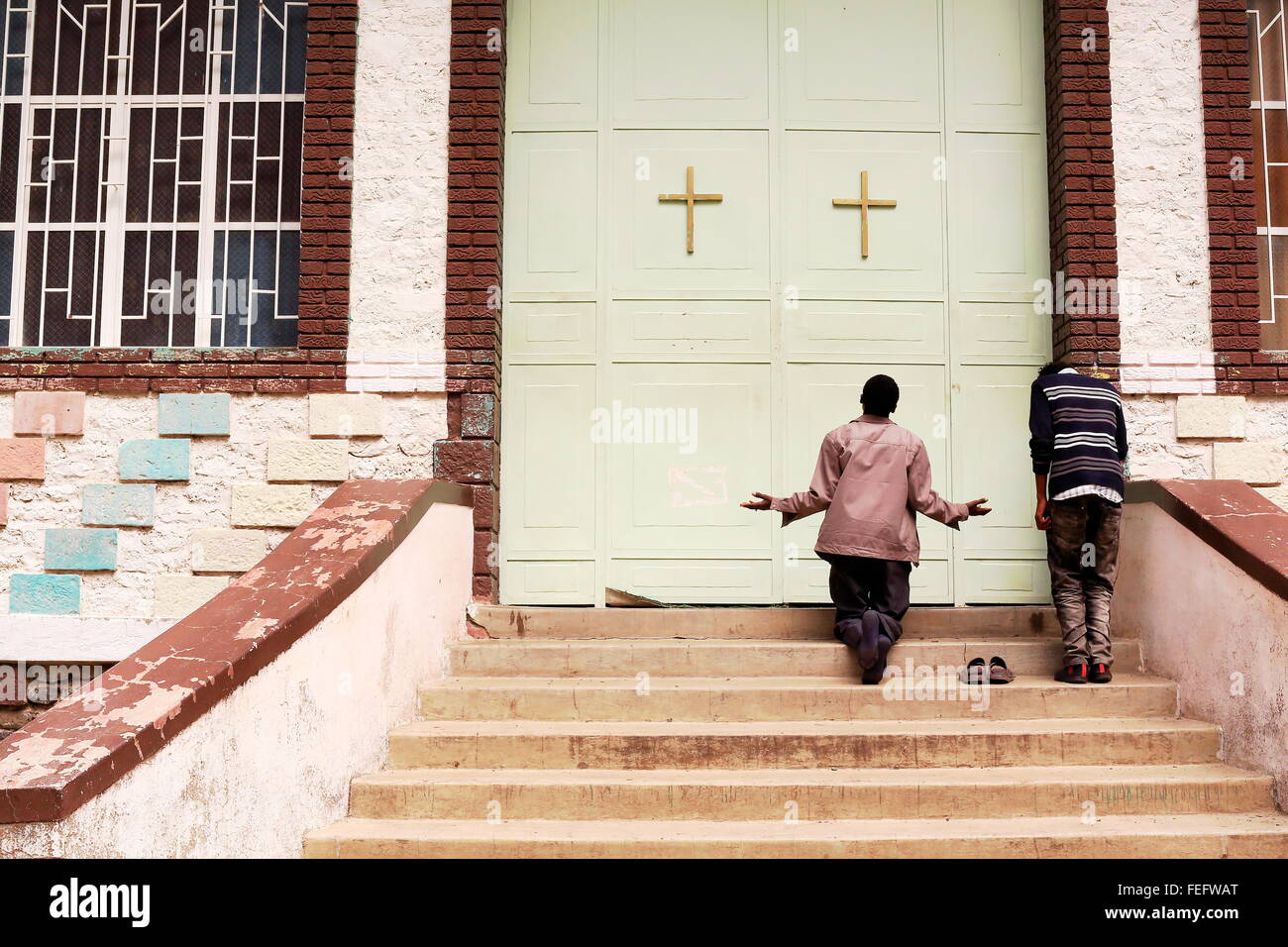 KOMBOLCHA-ETHIOPIA-MARCH 24: Men praying atop a stairway at the closed ...