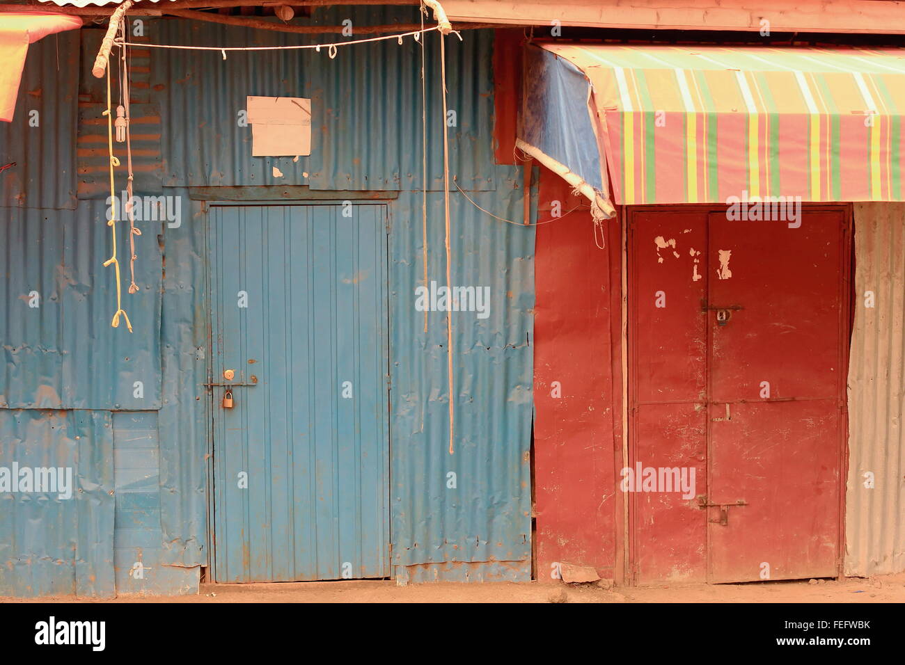 Tin doors painted blue and red of closed shops-area surrounding the ...