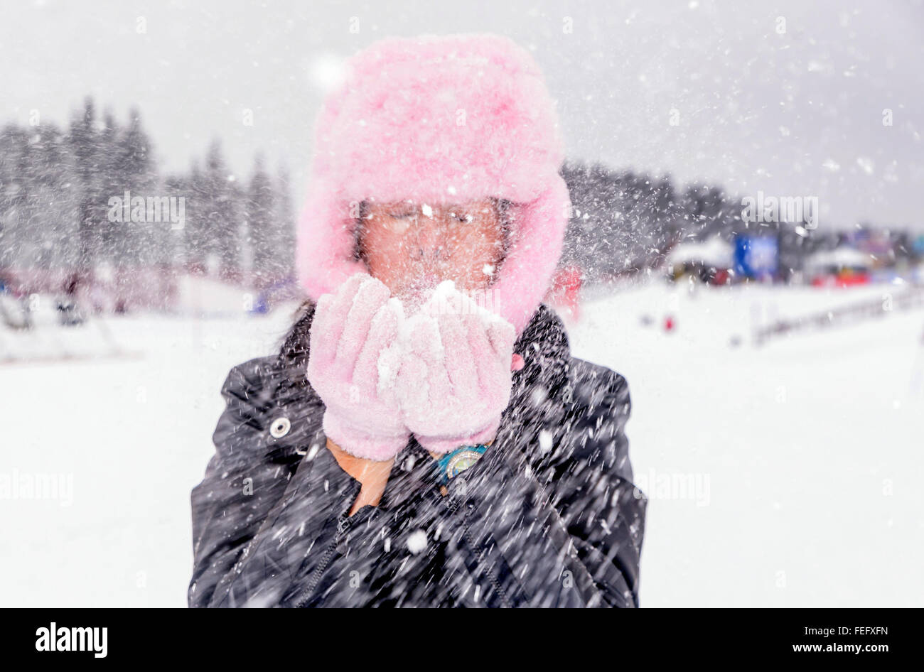 Young women blowing snow abstract Stock Photo - Alamy