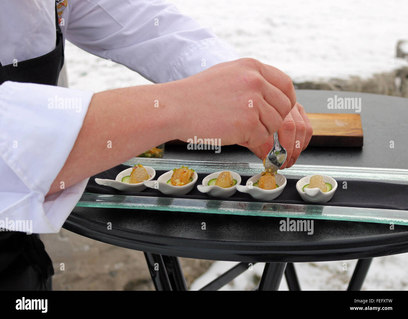 chef plating up smoked scallops Stock Photo - Alamy
