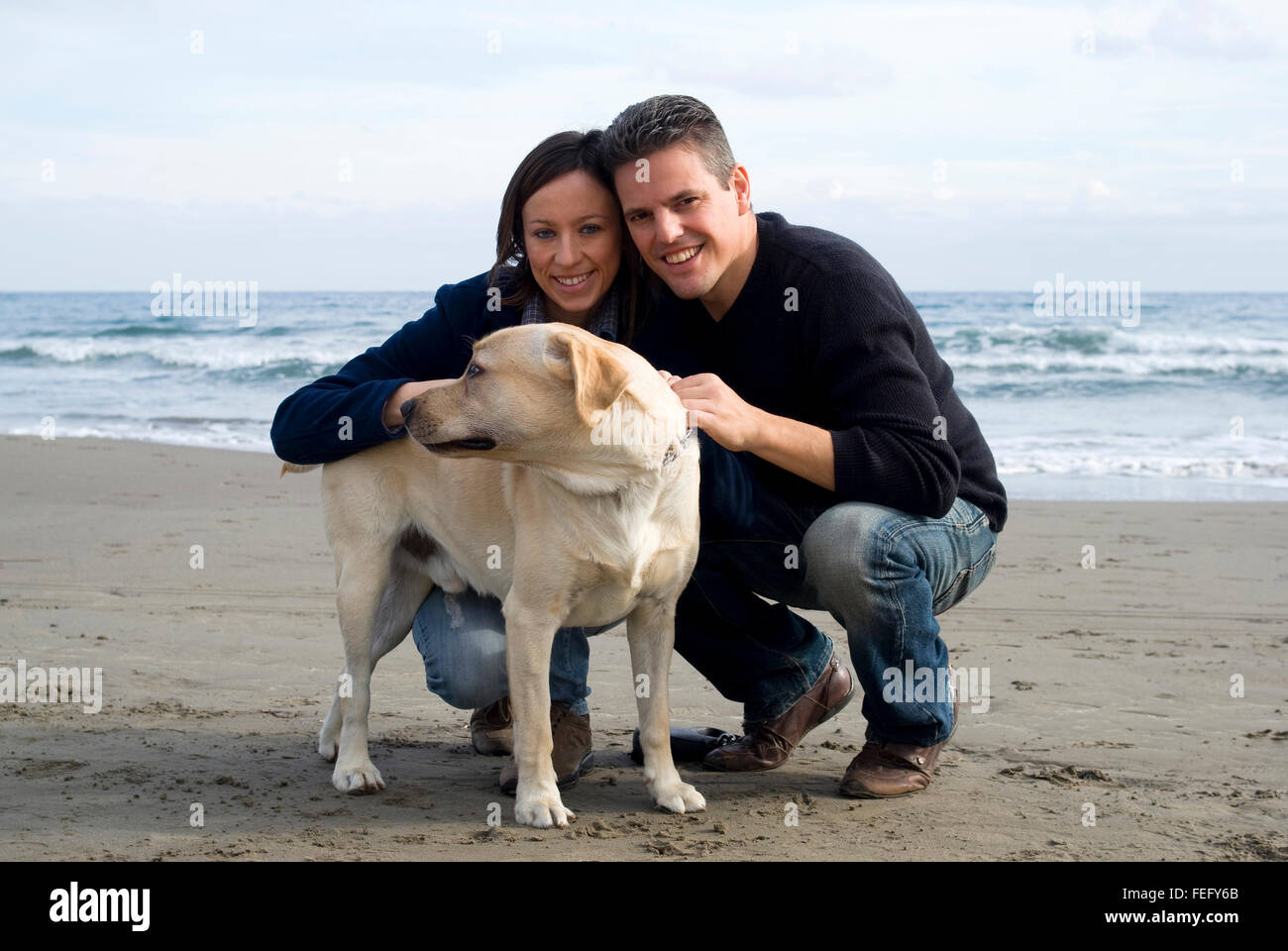 Happy couple with their Labrador Stock Photo - Alamy