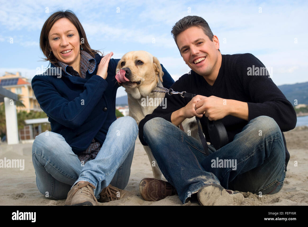 Happy couple enjoying themselves with their Labrador Stock Photo - Alamy