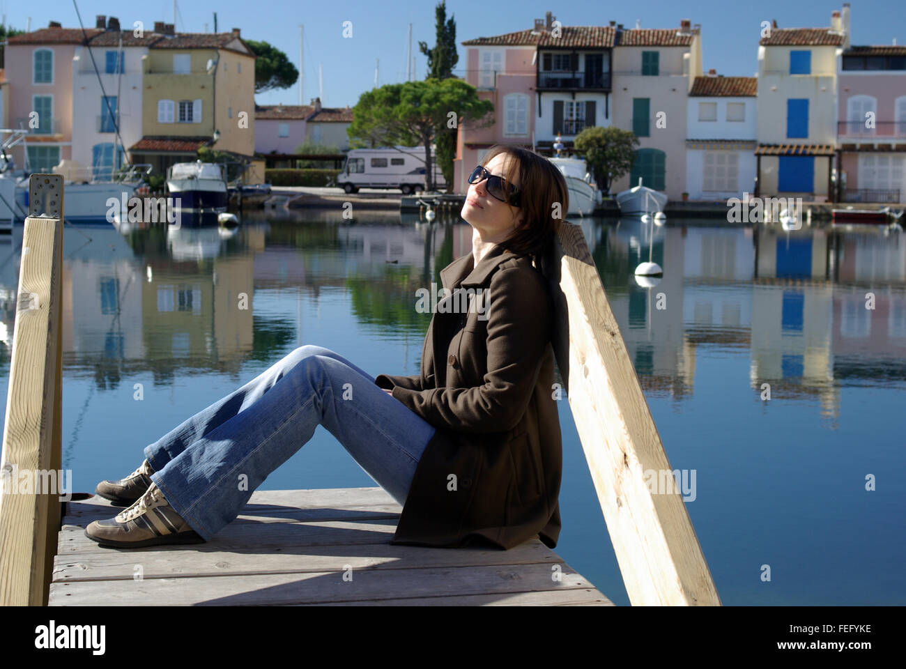 Woman relaxing on the pier Stock Photo - Alamy