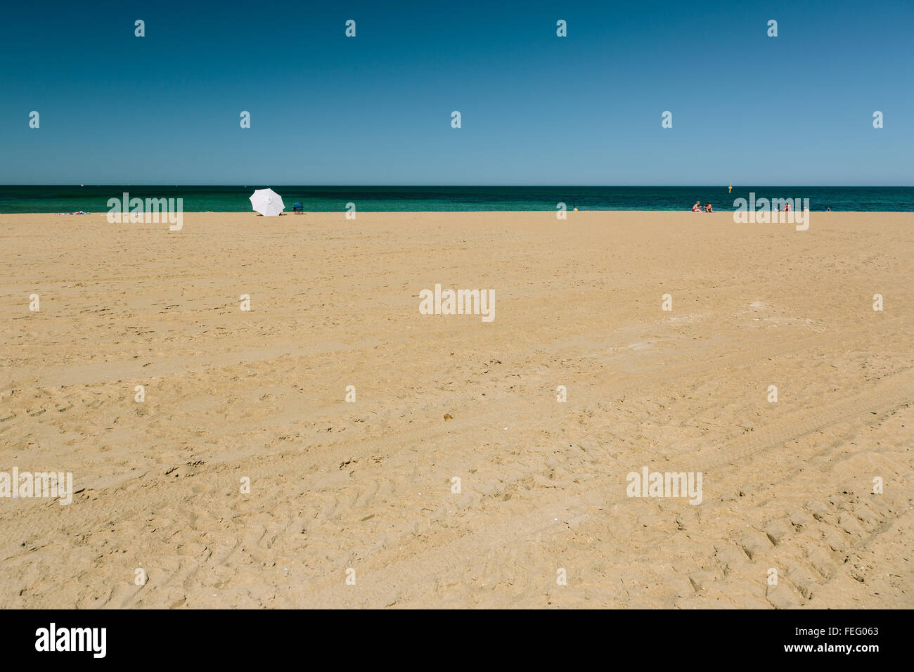 Mordialloc Beach in Melbourne. A large white umbrella near the ...