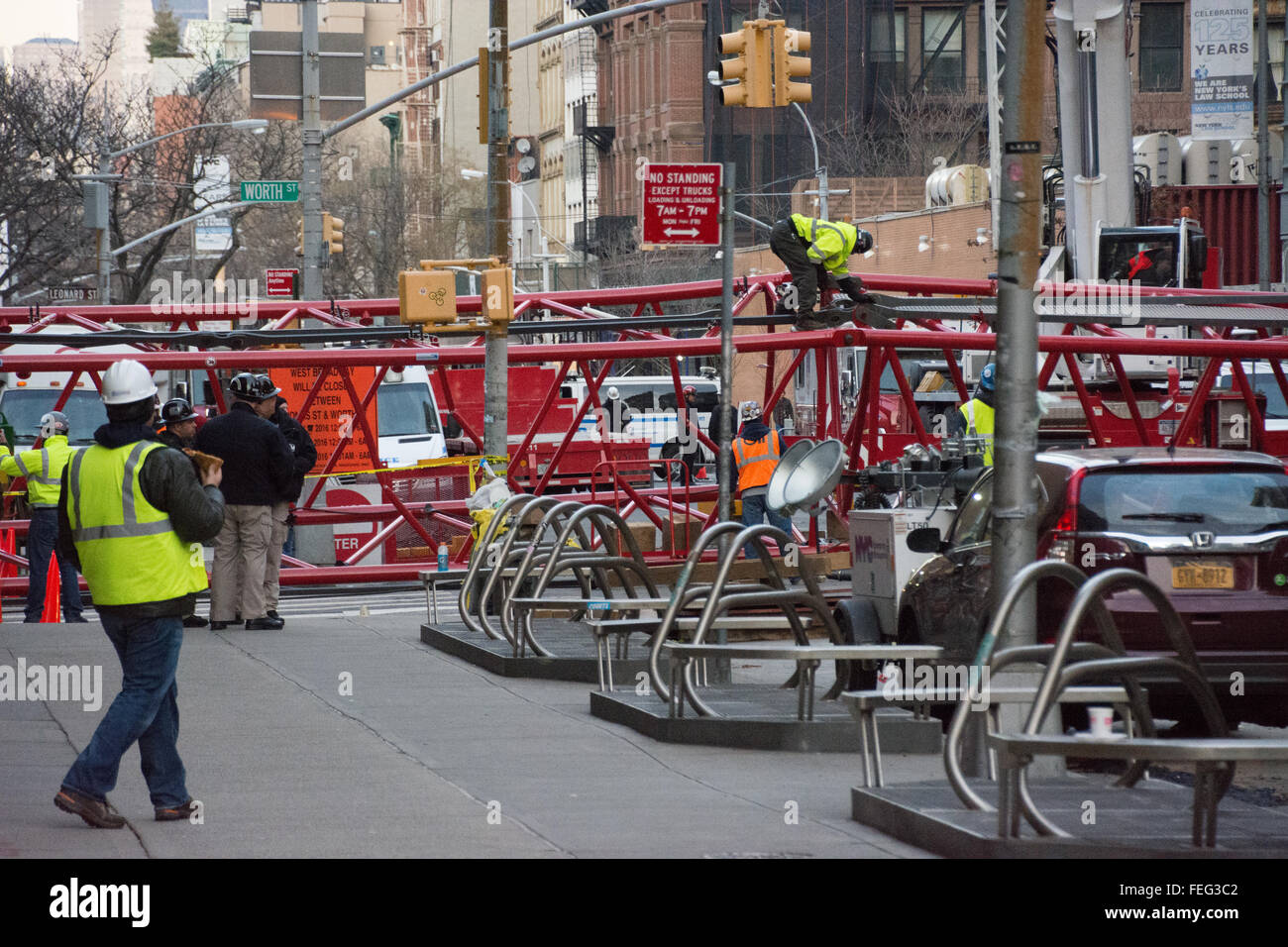New York, USA. 06th Feb, 2016. Workers dismantle collapsed crane boom ...
