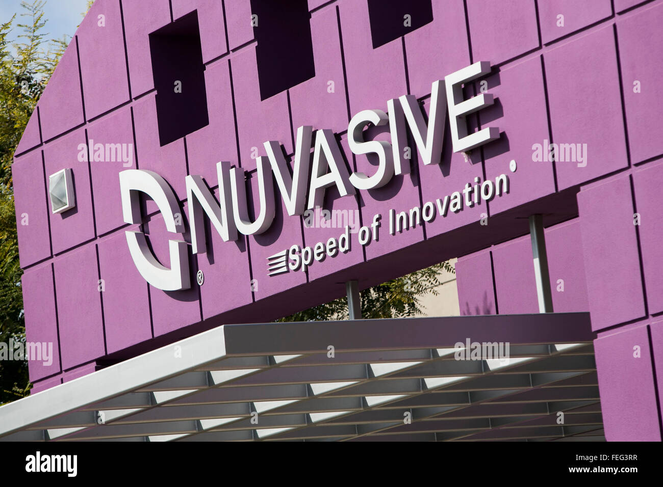 A logo sign outside of the headquarters of NuVasive, Inc., in San Diego ...
