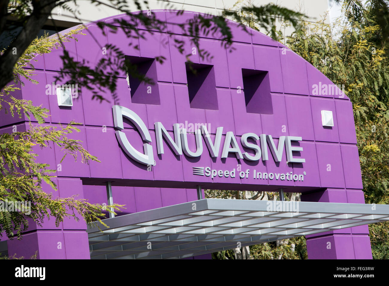 A logo sign outside of the headquarters of NuVasive, Inc., in San Diego ...