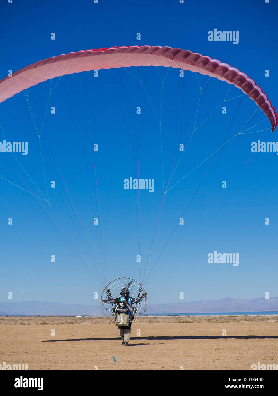 A paramotoring pilot gets ready for takeoff in his paramotor at a ...