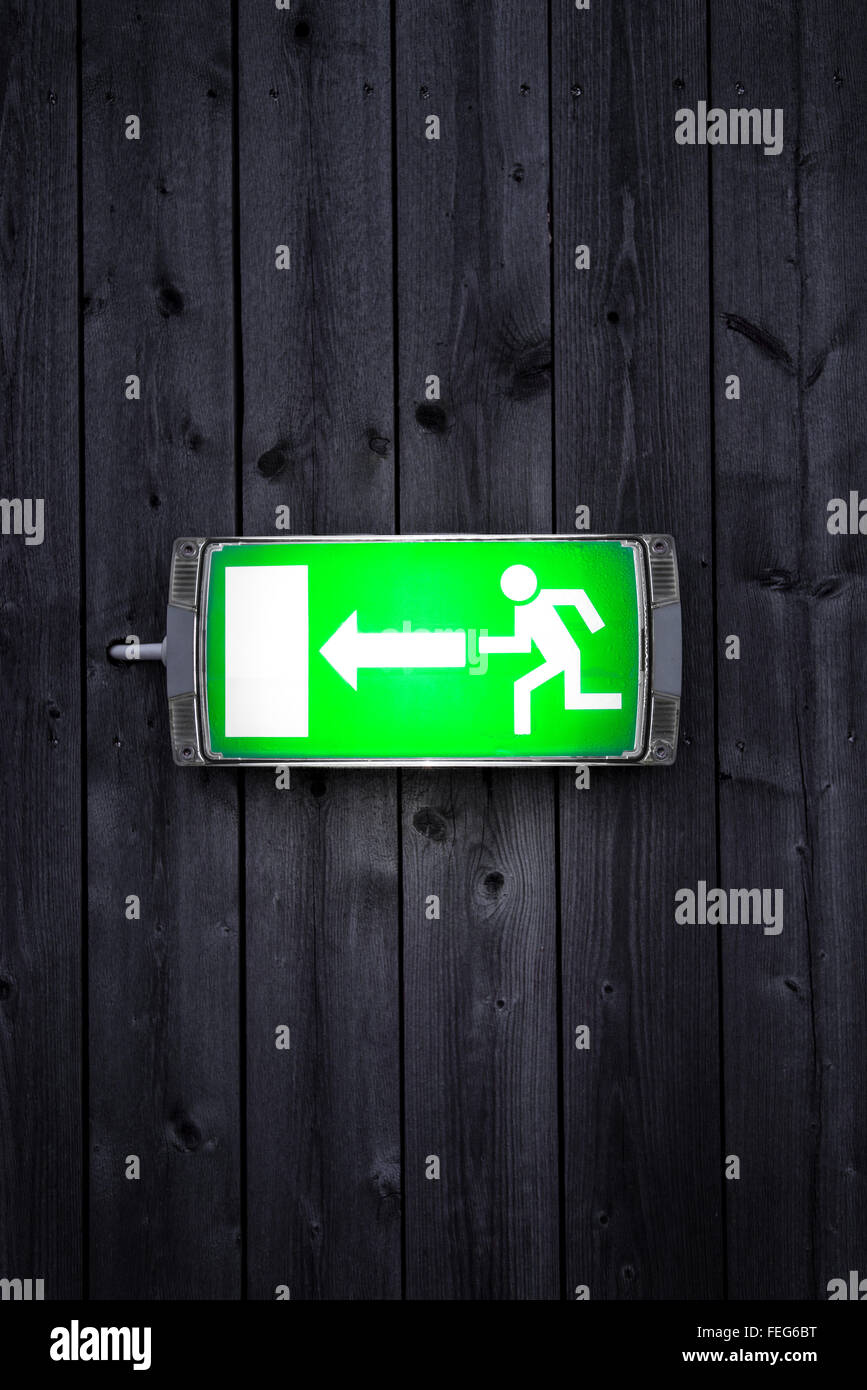Emergency exit sign on wooden plank wall Stock Photo - Alamy