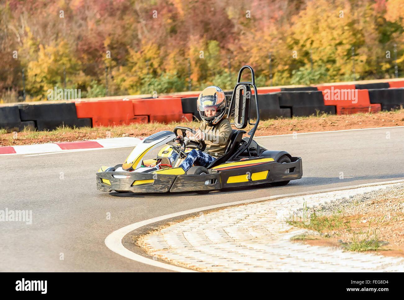Little girl is driving Go- Kart car in a playground racing track Stock ...