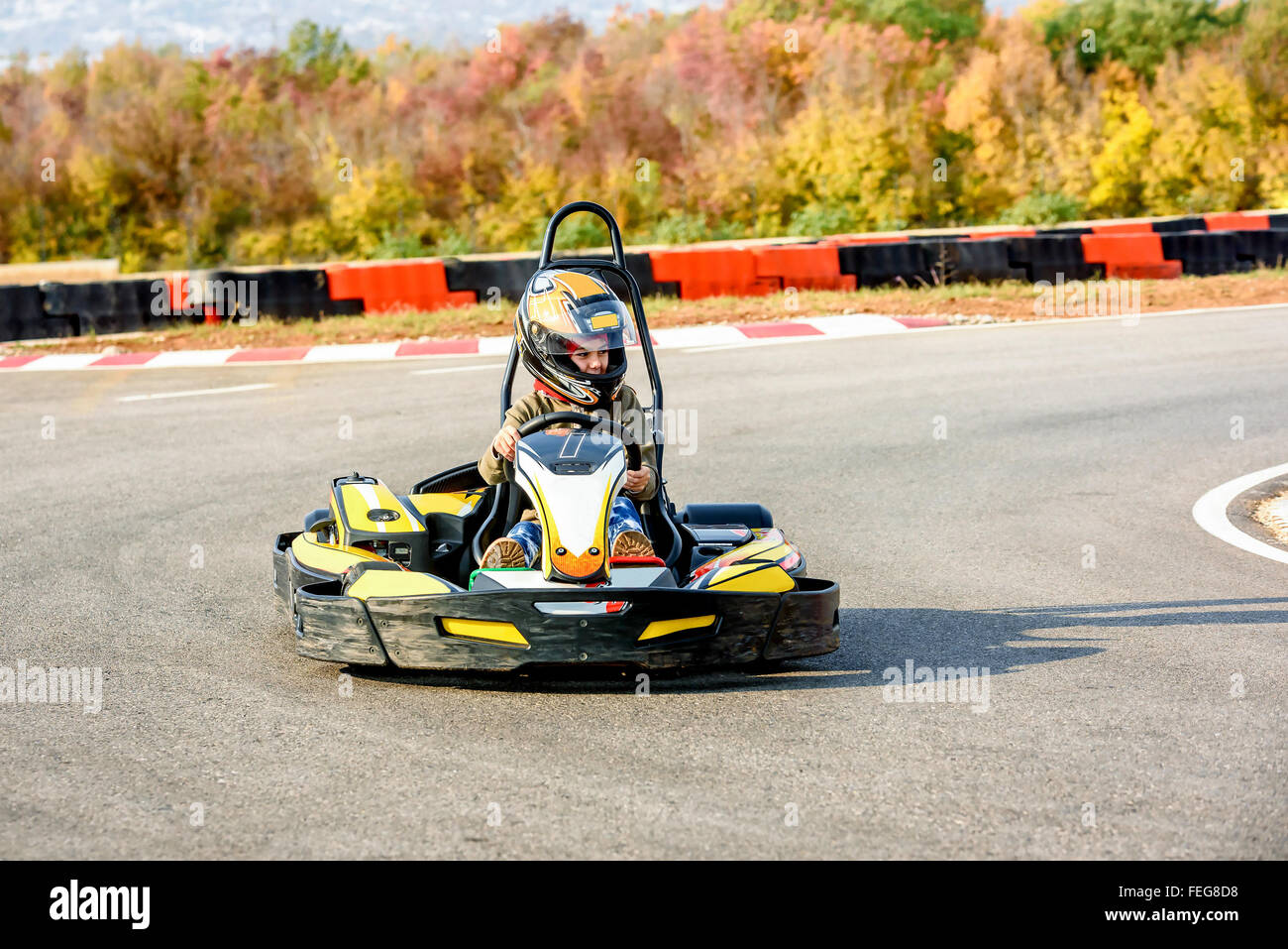 Little girl is driving Go- Kart car in a playground racing track Stock ...