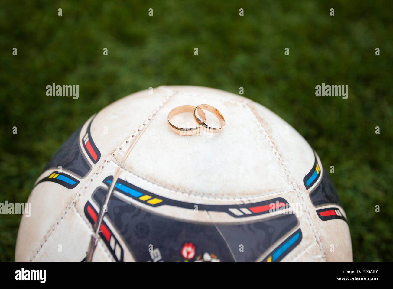 gold wedding rings and football Stock Photo - Alamy