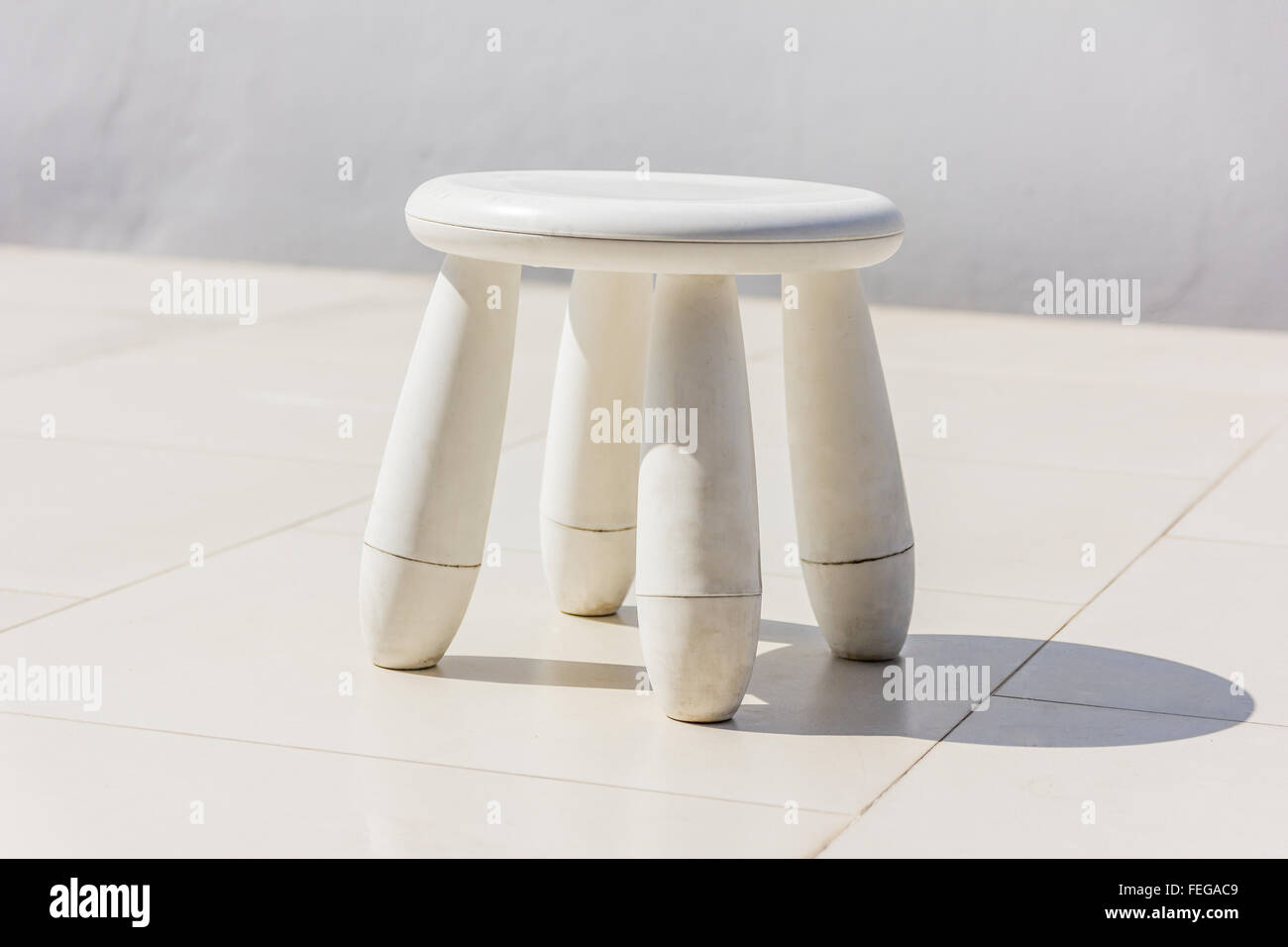 Old baby white plastic stool Stock Photo - Alamy