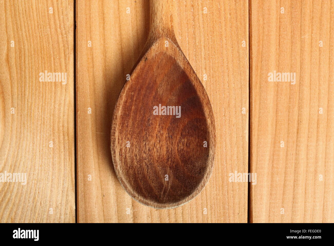 Wooden spoon at plank background Stock Photo - Alamy