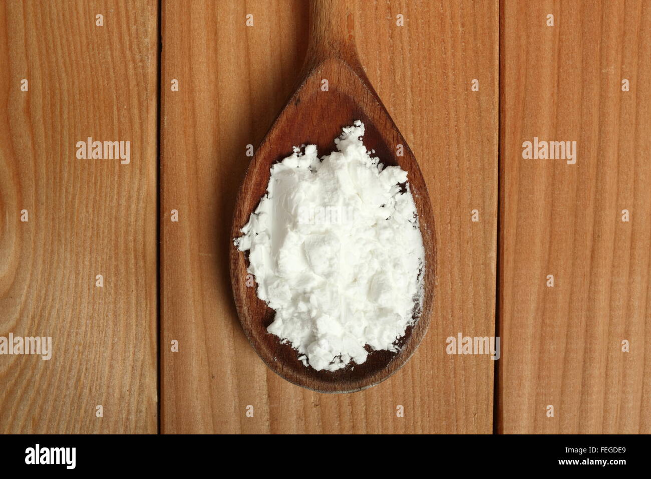 Starch (amylum) on wooden spoon at plank background. Directly Above ...