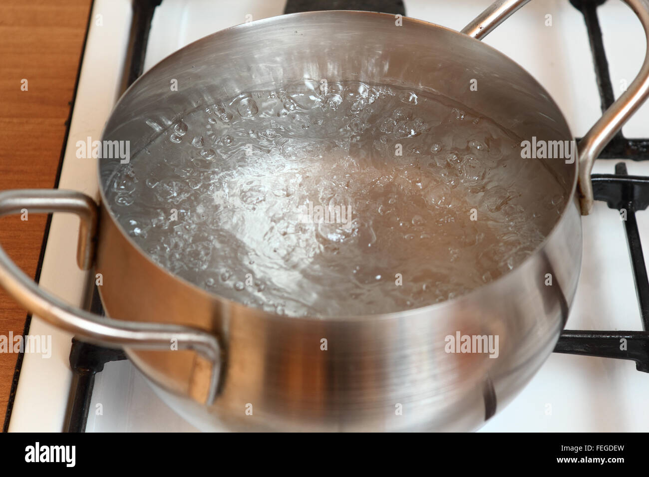 Boiling water on gas stove Stock Photo - Alamy